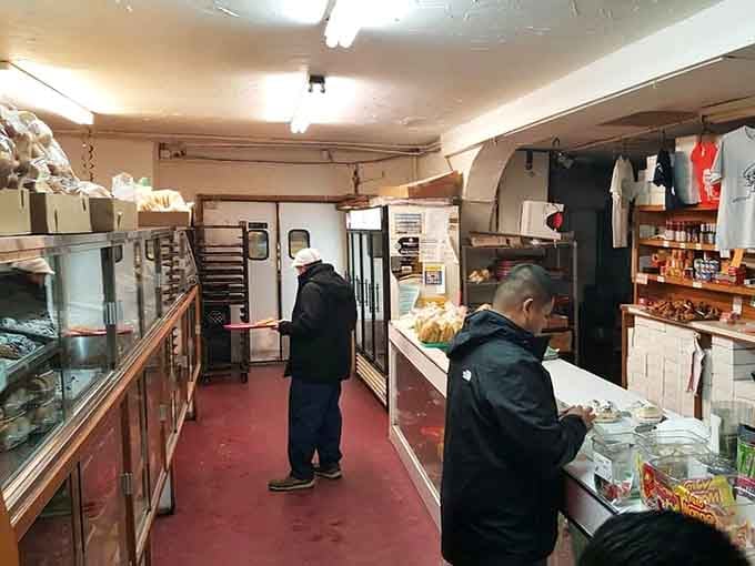 Trays in hand, customers move through La Gloria Bakery like they already know exactly what they came for.