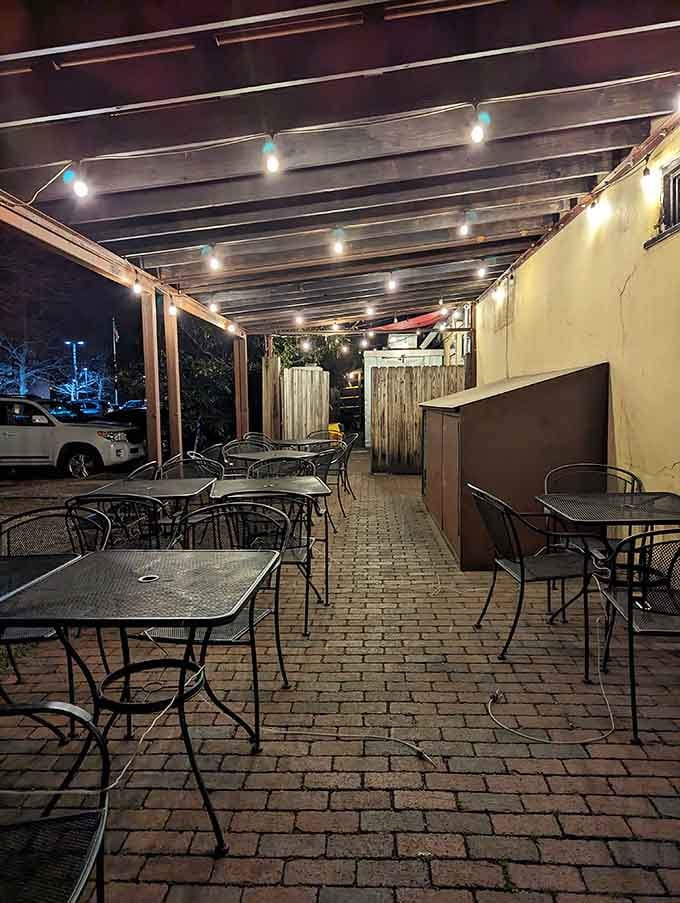 The brick patio extends the dining space, offering al fresco enjoyment of Neapolitan excellence under string lights.