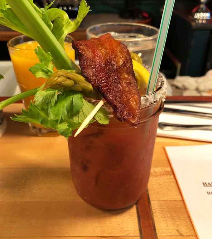 This Bloody Mary comes dressed for success with bacon, celery, and enough garnishes to qualify as a salad course.