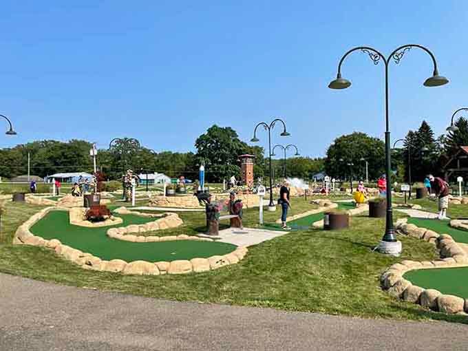 Miniature golf course winding through carefully designed obstacles, where putting skills matter less than the company you're keeping today.