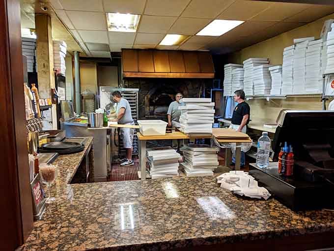 Watch the masters at work, tossing dough and tending the coal-fired oven like conductors leading a symphony orchestra.