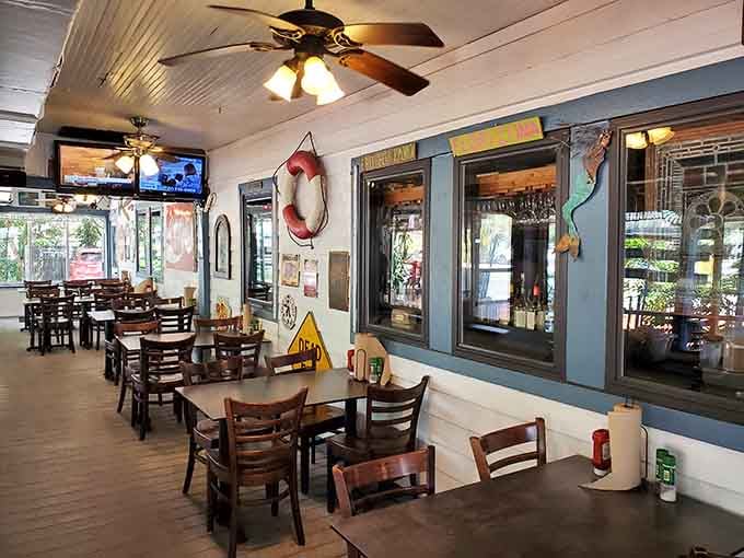 The covered patio offers that perfect Florida outdoor dining experience with ceiling fans and nautical touches throughout.