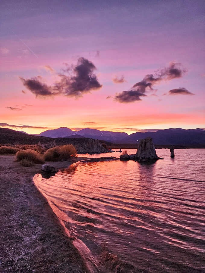 Purple and pink skies at dusk transform the tufa formations into silhouettes worthy of any gallery wall.