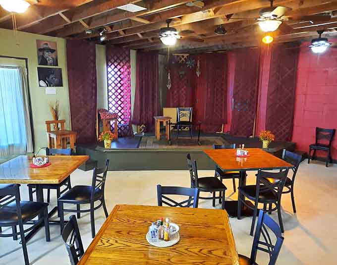 Colorful dining room with wooden tables where community happens naturally over plates of comfort food daily.