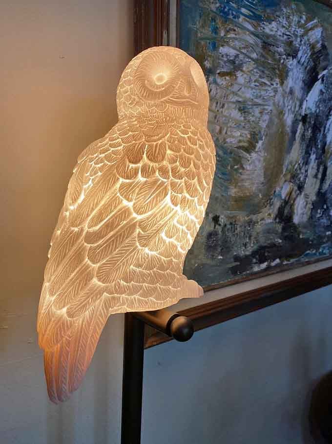 This glowing owl lamp perched on the railing adds the perfect touch of Hedwig-inspired ambiance to the space.