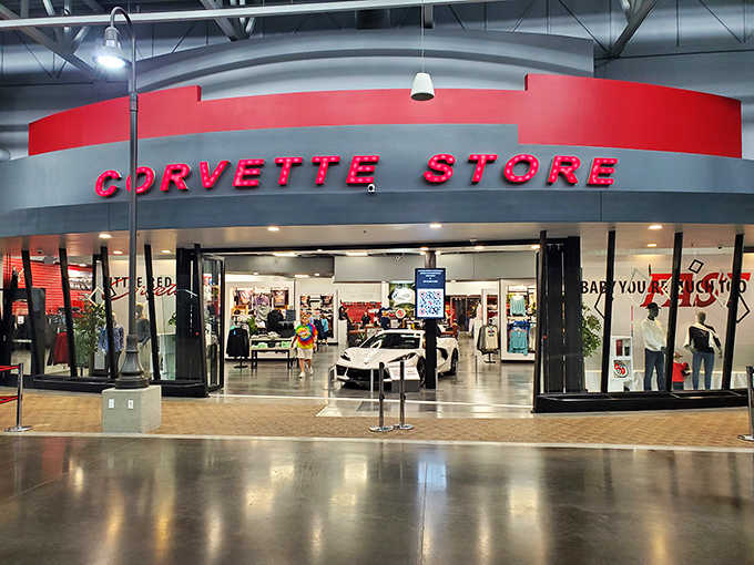 The gift shop entrance glows with promise, where your wallet goes to die but your Corvette obsession lives forever.