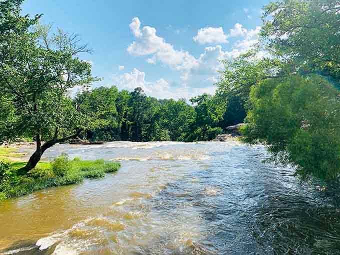The river continues its journey downstream, completely unbothered by tourists and their endless photo sessions above.
