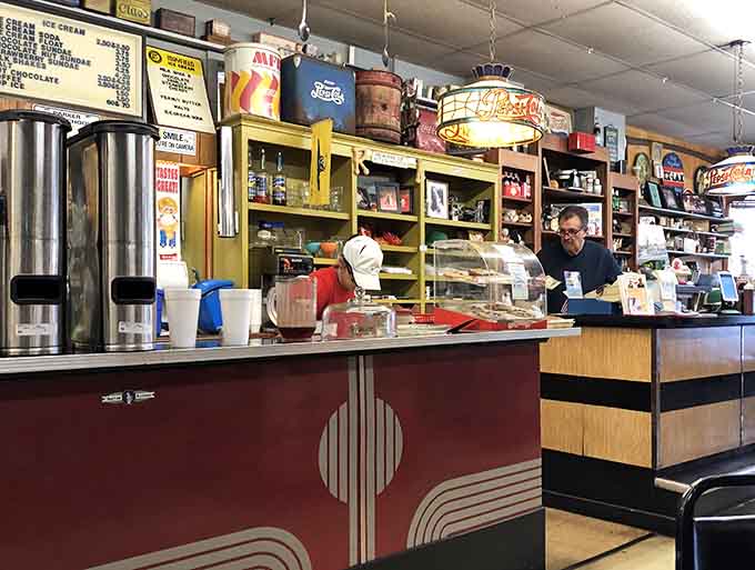 Behind that counter, amid vintage signs and collectibles, someone's crafting your order with practiced, unhurried precision and care.