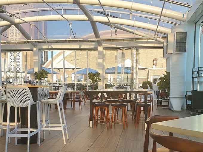 White chairs and natural light create that breezy, coastal vibe that makes you forget you're in the Midwest entirely.