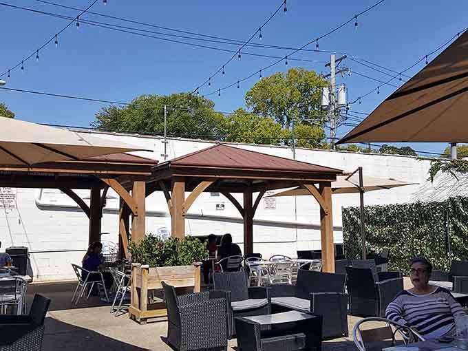 Outdoor seating under wooden pergolas proves that great food tastes even better with fresh air and sunshine.