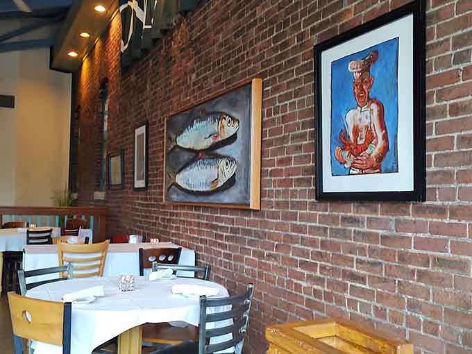 Fish artwork and brick walls create an atmosphere that whispers coastal charm without shouting about it too loudly.