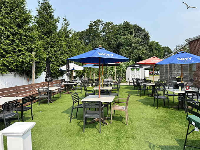 Tables under blue umbrellas offer the perfect spot to enjoy fish and chips while pretending you're across the pond.