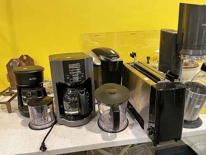 Coffee makers gathered like caffeinated companions, each one promising to brew your morning salvation at thrift-store prices.