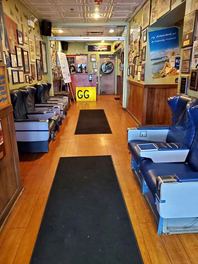That entrance hallway with airplane seats might be the most creative waiting area you'll ever experience before your table's ready.