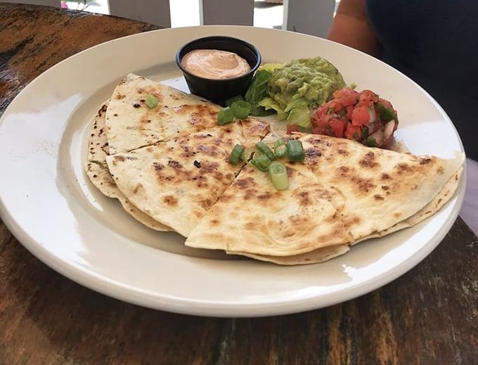 Quesadillas folded with care and served with all the fixings, comfort food that transcends any single cuisine.