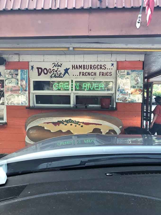 The take-out window with its giant hot dog sign makes ordering feel like participating in classic Americana history.