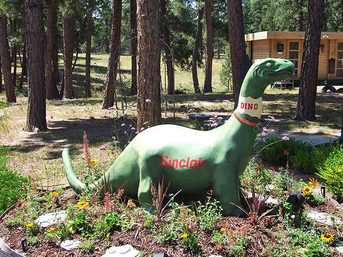 The Sinclair dinosaur stands guard, reminding us when gas stations had personality and prehistoric mascots made perfect sense.