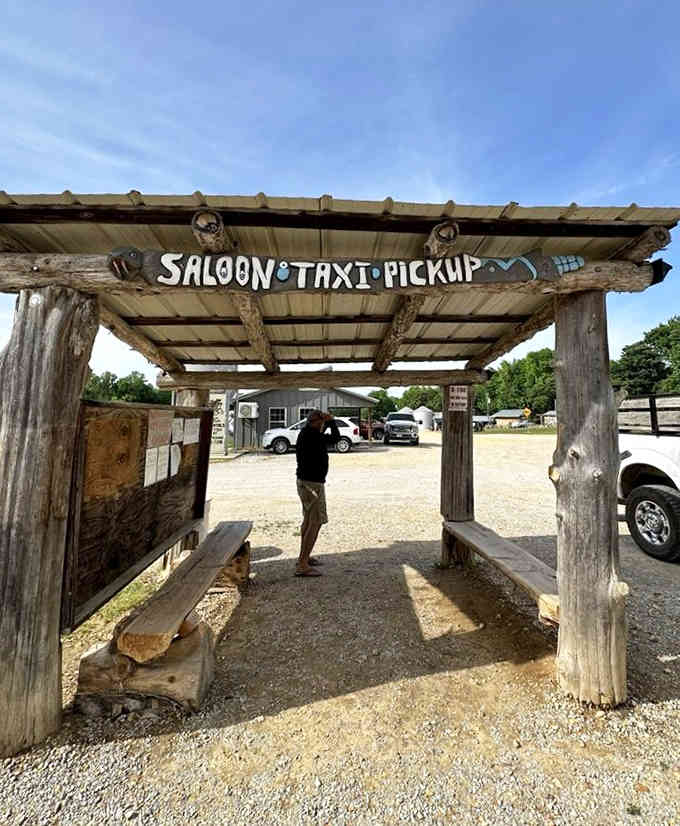 The "Saloon Taxi Pickup" sign marks where your tractor-pulled wagon adventure begins, because normal parking is for normal restaurants.