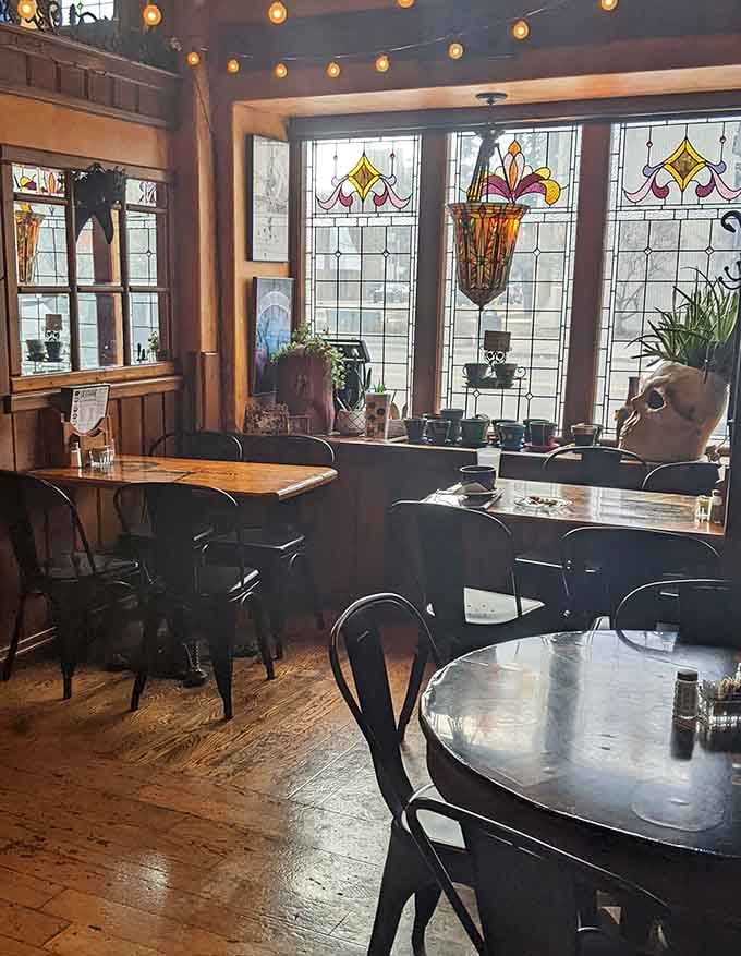 Stained glass windows and cozy seating arrangements make this corner feel like someone's really well-decorated living room, but with better coffee.