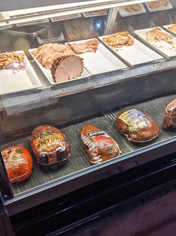 Fresh-sliced meats waiting in the case like actors backstage, ready for their starring role in your lunch.