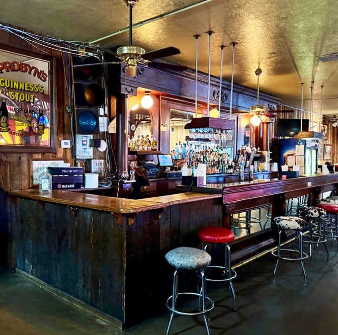The classic bar counter with vintage posters and warm lighting creates that timeless roadside caf&eacute; atmosphere perfectly executed.