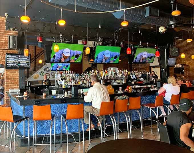 Orange chairs pop against the industrial bar where craft beers and cocktails flow as freely as conversation and laughter.