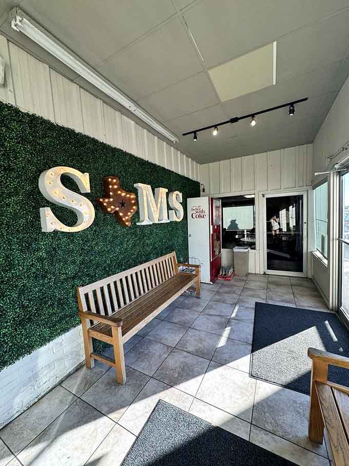 Even the waiting area welcomes you with style, featuring illuminated letters and comfortable seating options.