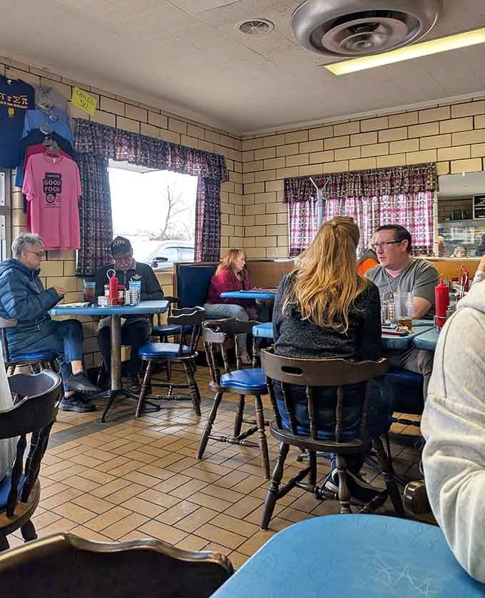 Real people enjoying real food in a real diner, no phones out, just folks actually talking to each other.