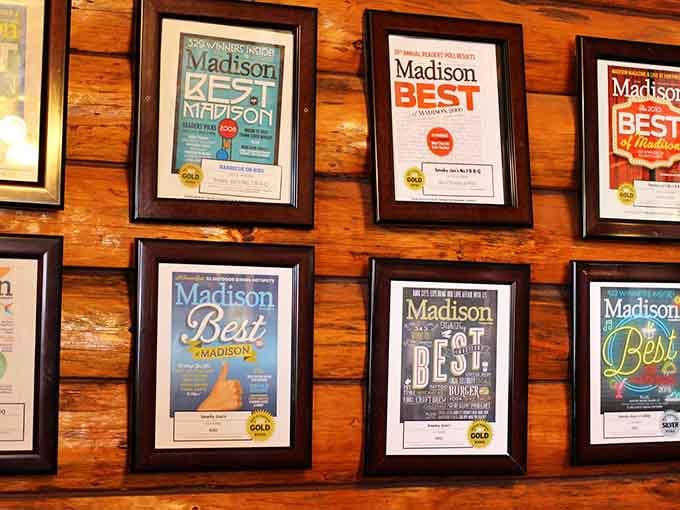 This wall of "Best of Madison" awards isn't decoration, it's documentation of years spent perfecting the craft of barbecue.