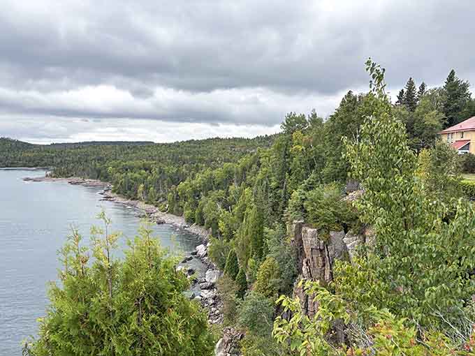 The forested shoreline stretches endlessly, reminding you that Lake Superior's beauty extends far beyond the lighthouse itself.