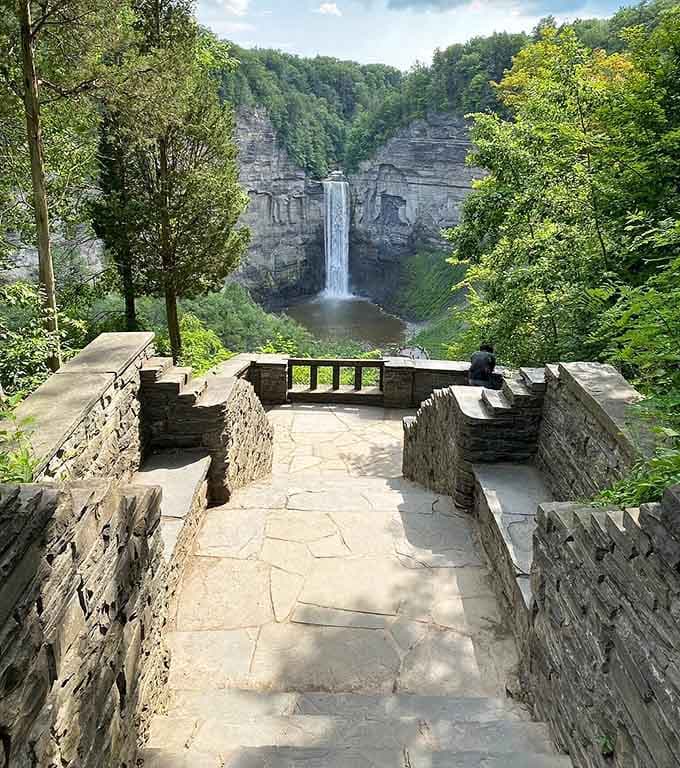 The stone observation deck provides the perfect vantage point for waterfall gazing and contemplative life moments.