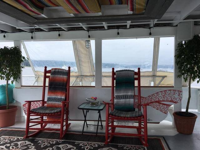 Rocking chairs with a view proving that relaxation is an art form best practiced on water.