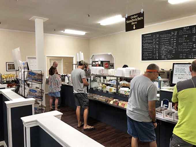The ordering counter where dreams come true and sandwich decisions become surprisingly difficult life choices requiring serious contemplation.