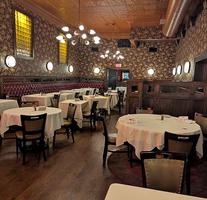 Empty tables waiting for evening guests stand ready like a stage before curtain call, anticipating tonight's delicious performance.