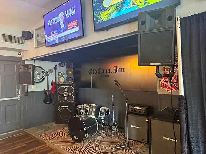 A drum kit and stage setup suggest that live music happens here, because nothing says rock and roll like death-themed d&eacute;cor.