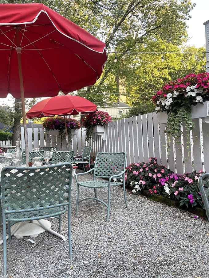 Outdoor seating surrounded by flowers makes dining al fresco feel like you've crashed a very upscale garden party.