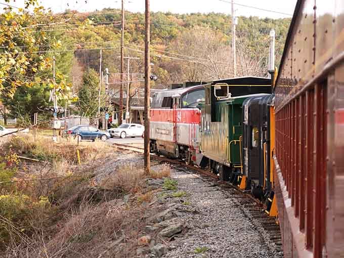 Watching the train navigate through town feels like stepping into a Norman Rockwell painting, except this one's real and happening right now.