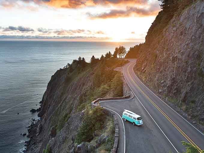 Sunset paints the coastal highway in golden light, turning an ordinary drive into pure magic.