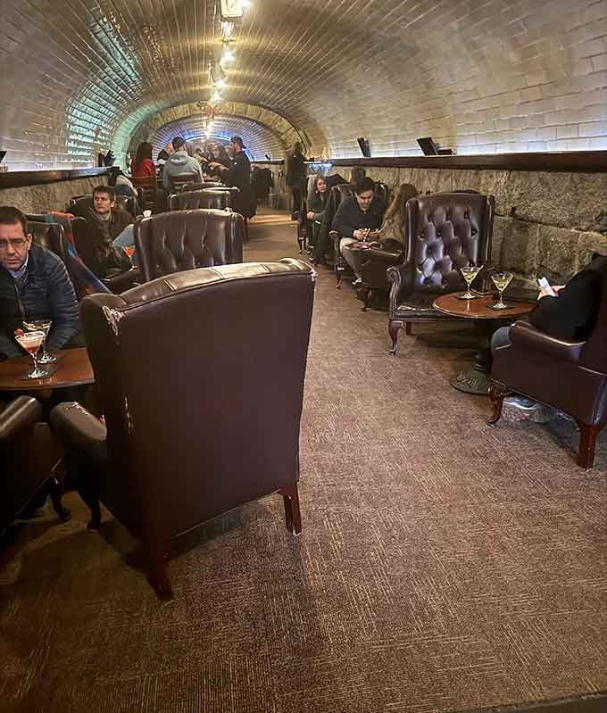 Real people enjoying real drinks in a real tunnel, living their best underground life while the world passes overhead.