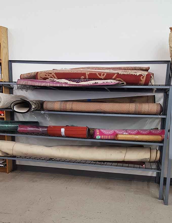 Rolled rugs waiting patiently like they're auditioning for a home makeover show and really want the part badly.