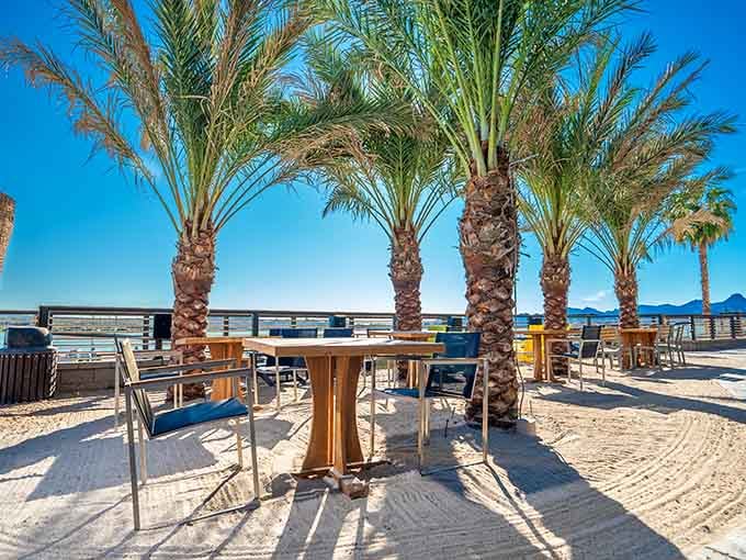 Sandy outdoor seating under palm trees where flip-flops are formal wear and worries evaporate quickly.