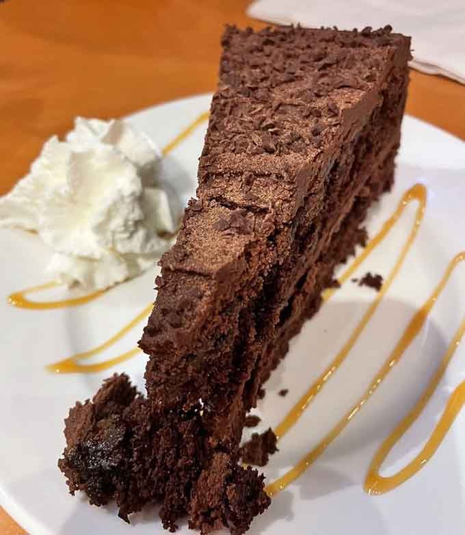 Chocolate cake with whipped cream and caramel drizzle, because you've earned dessert after conquering those ribs successfully.