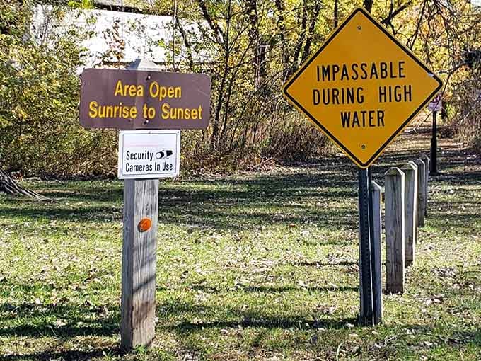 The signs remind you this area closes at sunset, because wandering historic bridges in the dark is how horror movies start.