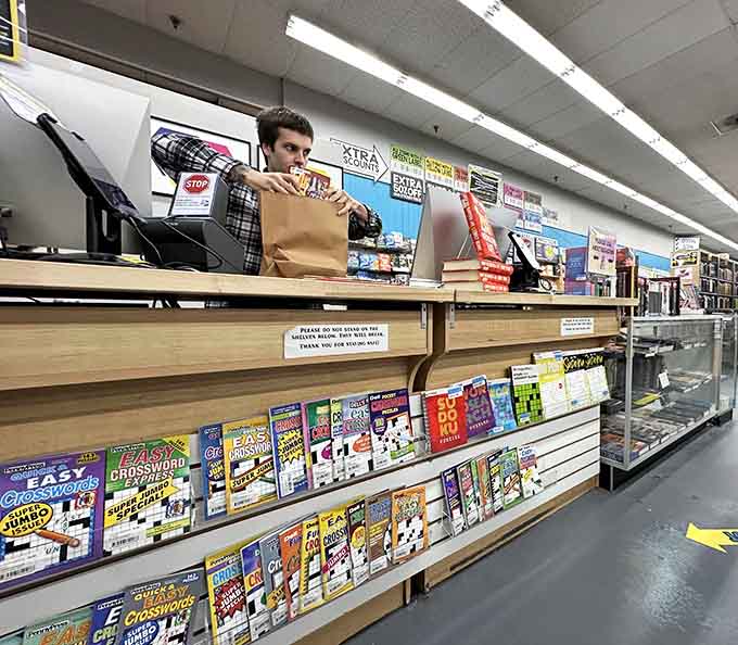 The checkout counter where your carefully curated stack of "just one book" somehow multiplied into a dozen.