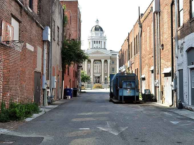Even the alleys have character here, with that courthouse dome reminding you that some places still value architectural beauty.