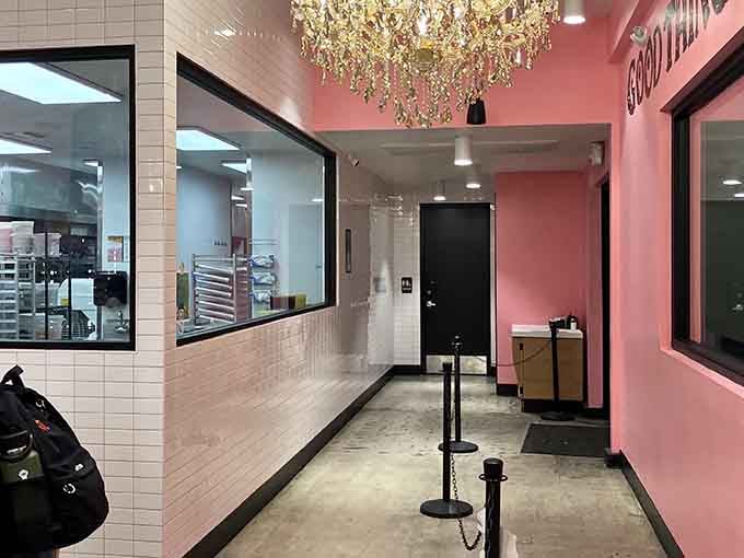Even the hallway to the restroom maintains that signature pink aesthetic, because commitment to a theme knows no boundaries here.