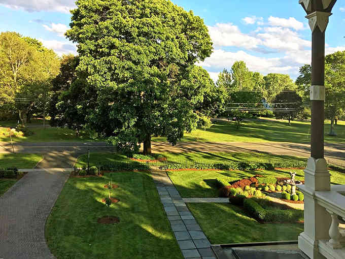 The view from a historic porch overlooks manicured lawns that have been tended with care for longer than most of us.
