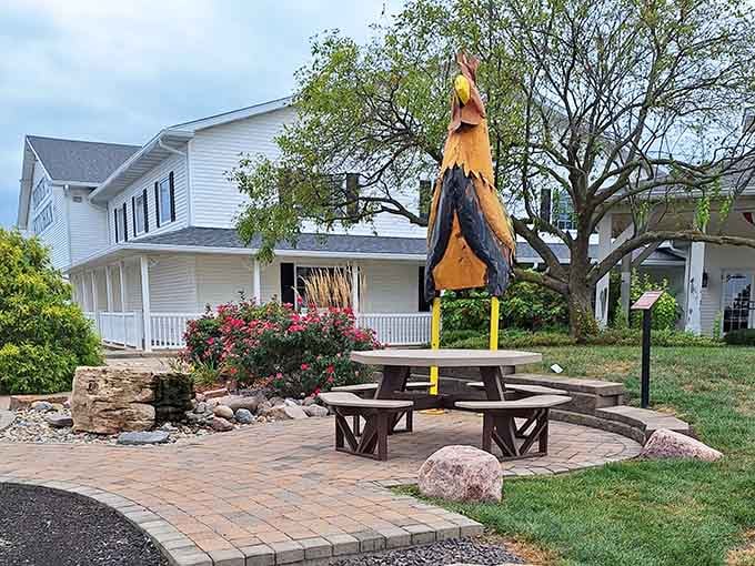 Outdoor seating with a giant chicken statue&mdash;because nothing says "we're serious about poultry" like oversized lawn art.