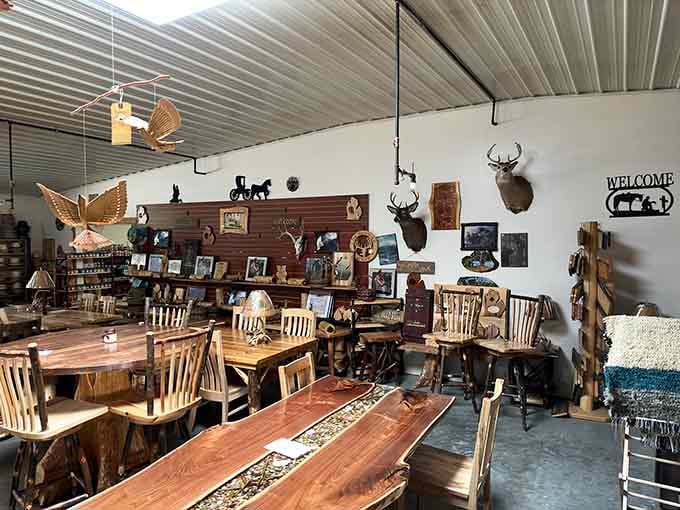 The showroom stretches on like a furniture lover's fever dream, with mounted deer heads keeping watch over the wooden kingdom below.