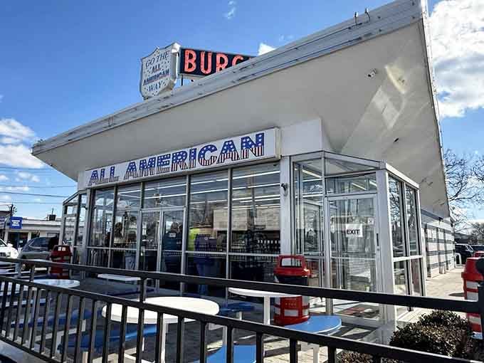 Under a bright blue sky, the All American Hamburger Drive In stands proud on Merrick Road, ready and waiting for you.